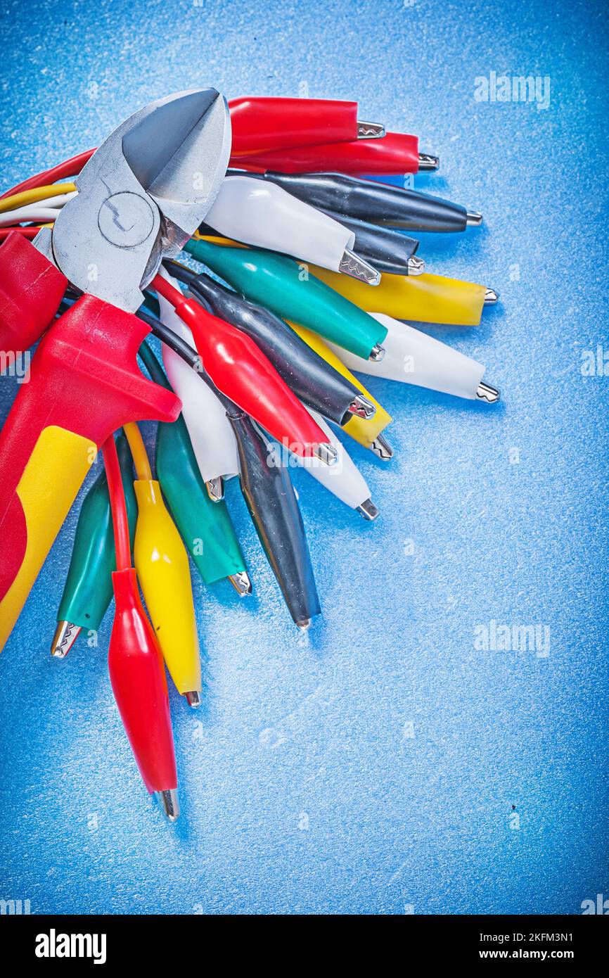 Electric crocodile plugs sharp nippers on blue background electricity ...