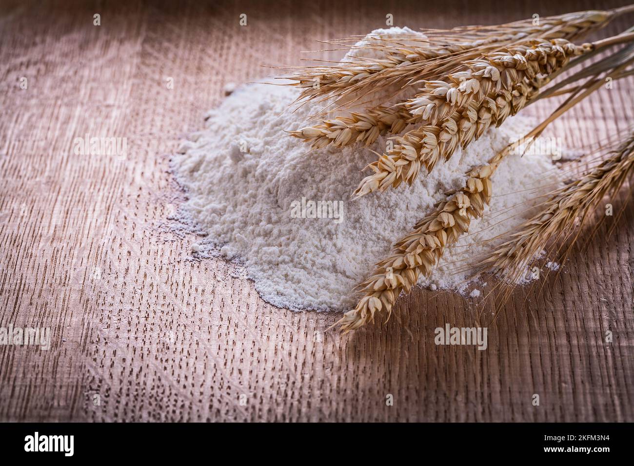 ears of rye little heap of flour on wooden board food and drink concept ...