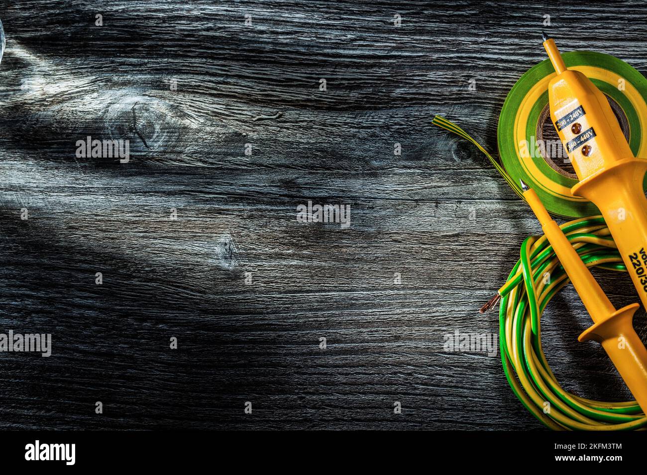 Electric tester hunk of rolled cable insulation tape on vintage wooden ...