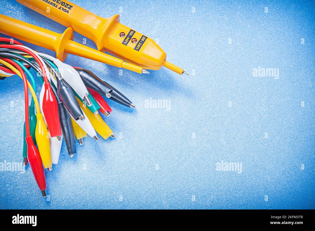 Electric tester crocodile clip cables on blue background electricity ...