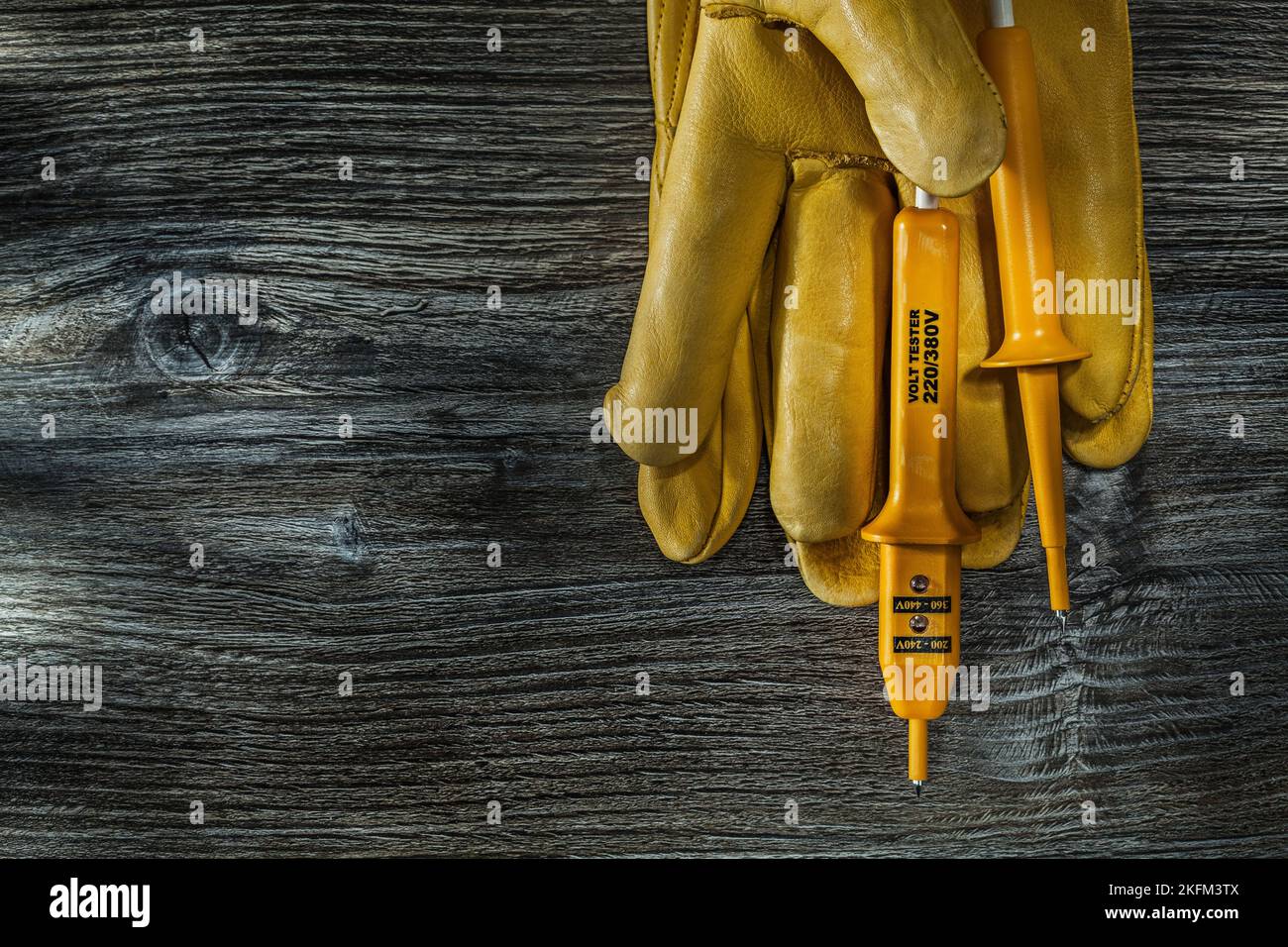 Electric tester leather safety gloves on vintage wooden board Stock ...