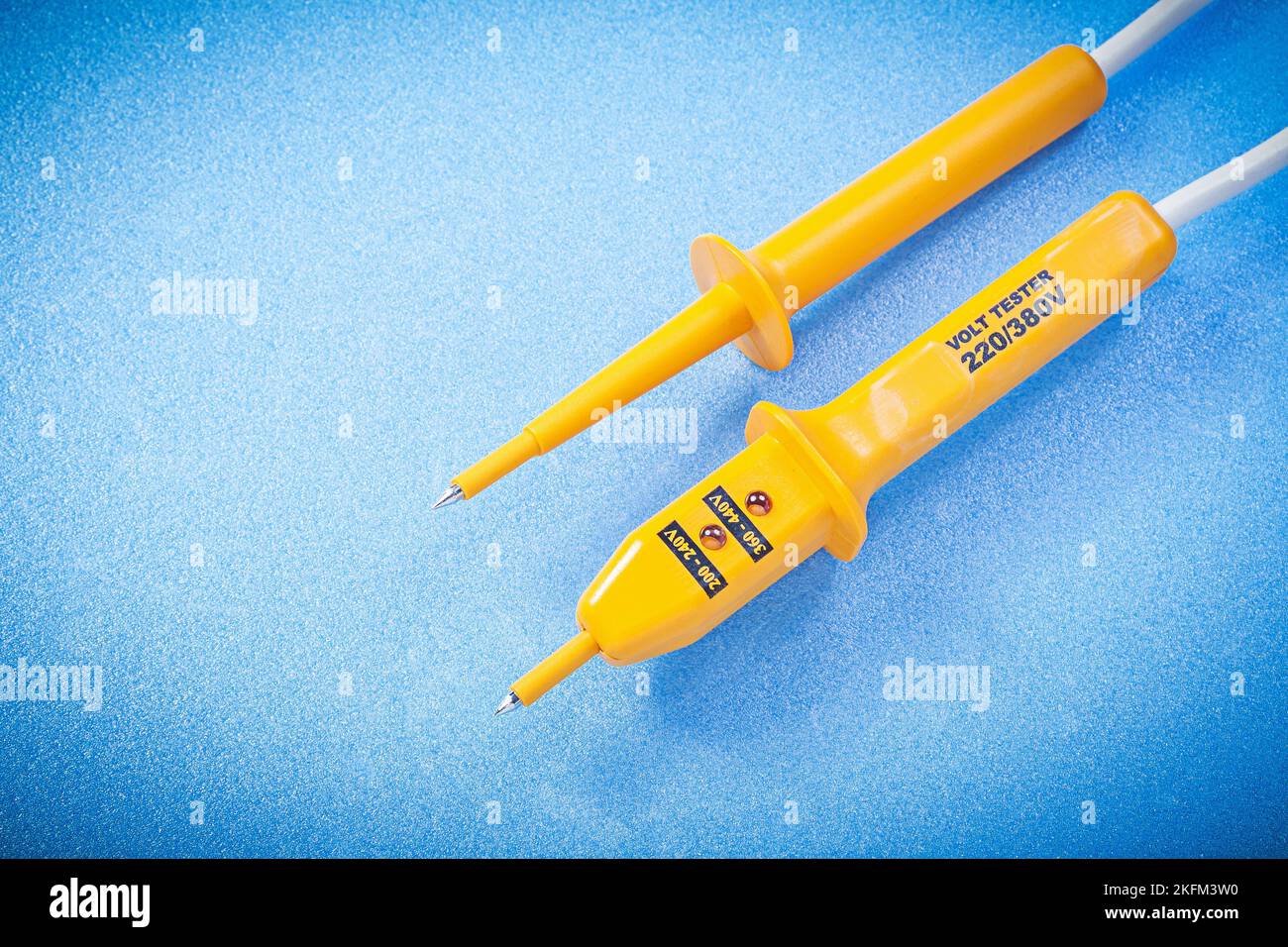 Electric tester on blue background electricity concept Stock Photo - Alamy