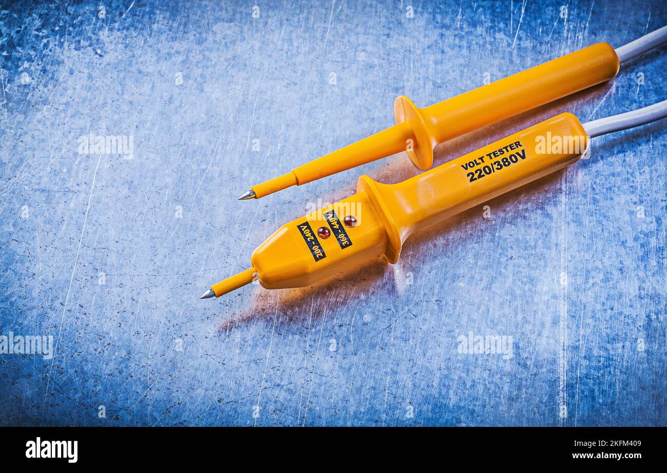 Electrical tester on scratched metallic background Stock Photo - Alamy