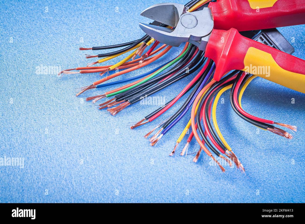 Electrical wires nippers on blue background electricity concept Stock ...
