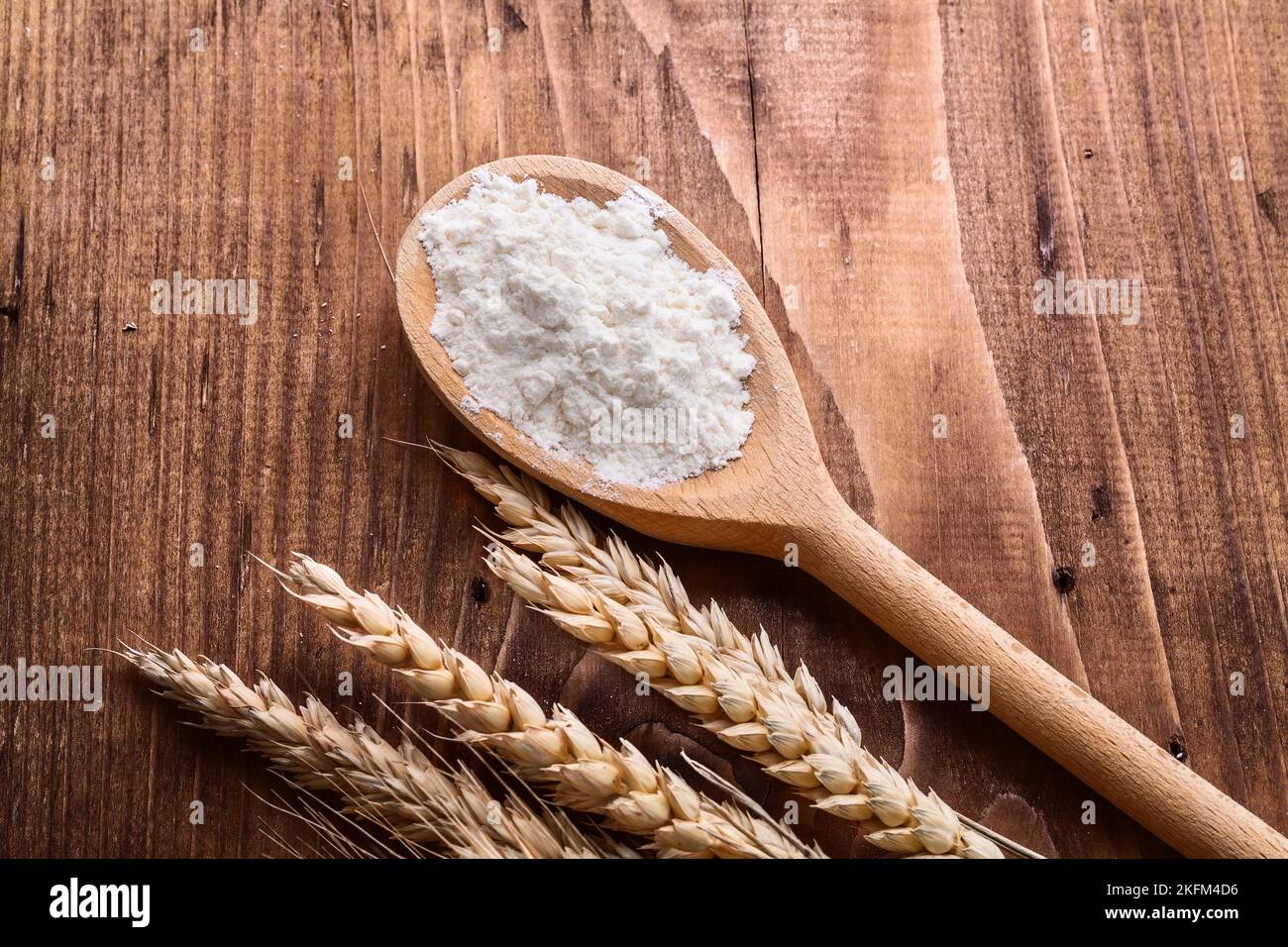 flour in wooden spoon with rye ears on vintage board Stock Photo - Alamy