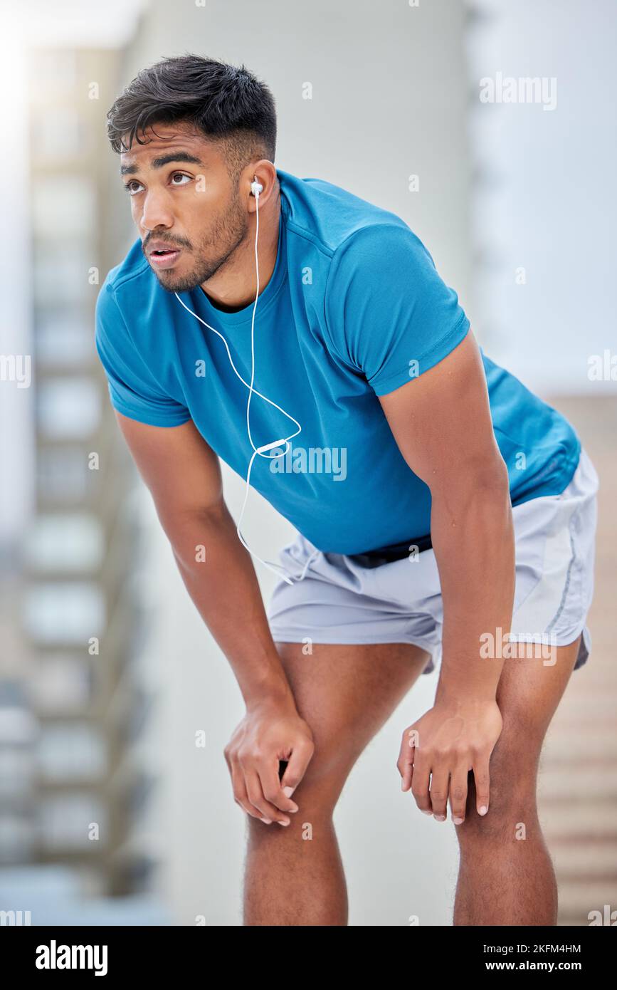 Tired, fitness and sweat with earphones music for cardio, workout and ...