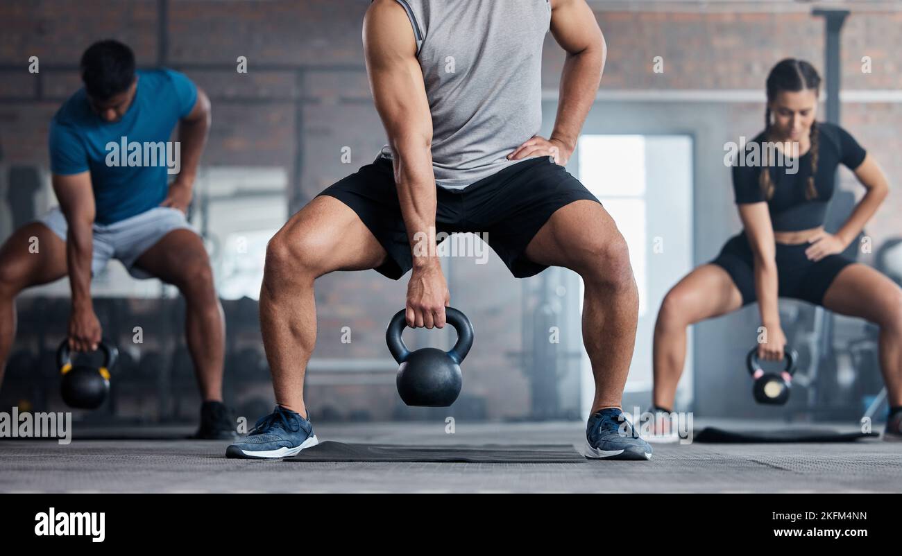 Fitness class, exercise and gym group with kettlebell for a workout and ...