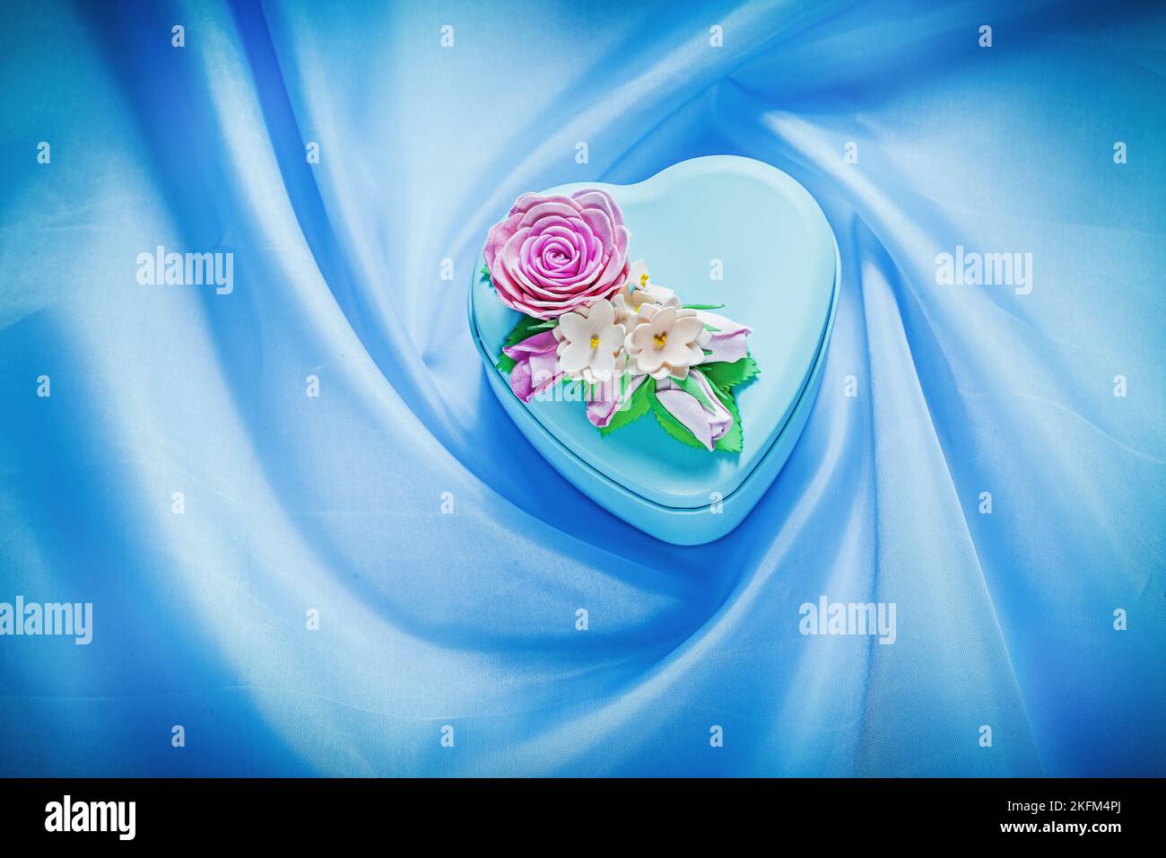 Gift box on blue fabric background celebrations concept Stock Photo - Alamy