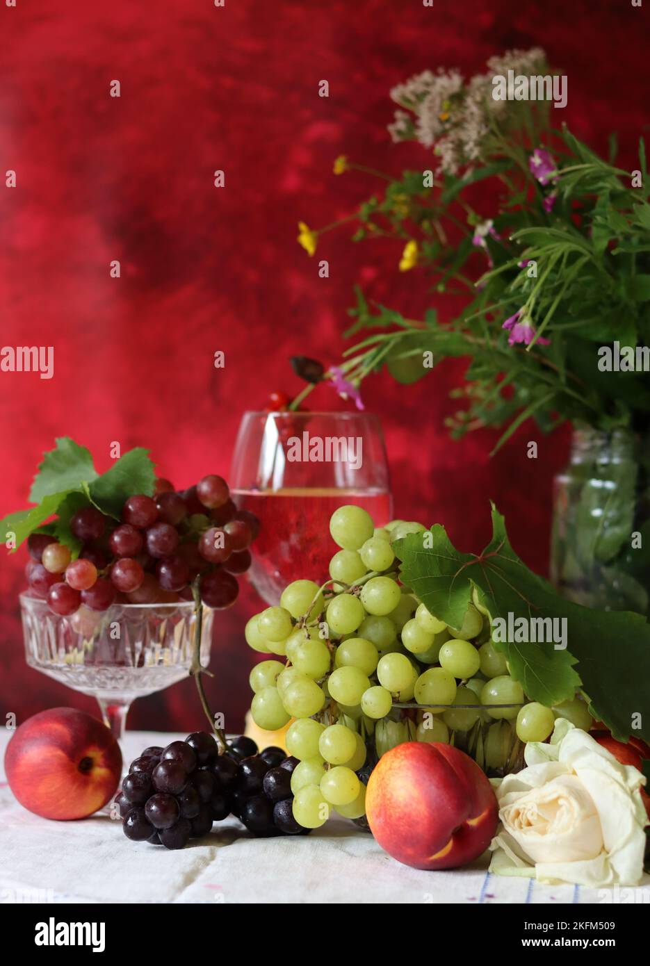 Still life with glass of rose wine, fresh seasonal berries and fruit ...