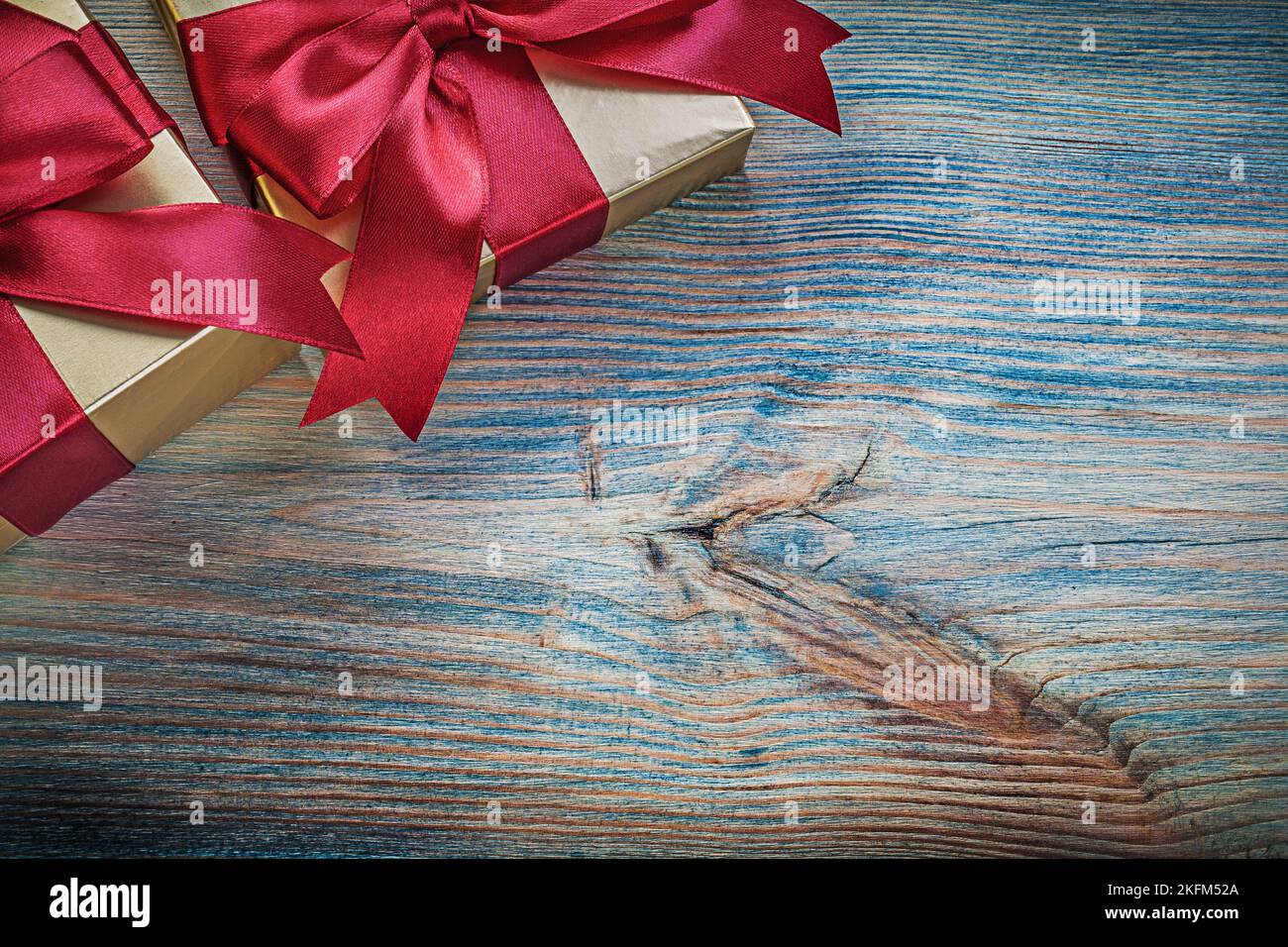 Gift boxes with tied bows on vintage wooden board holidays concept ...