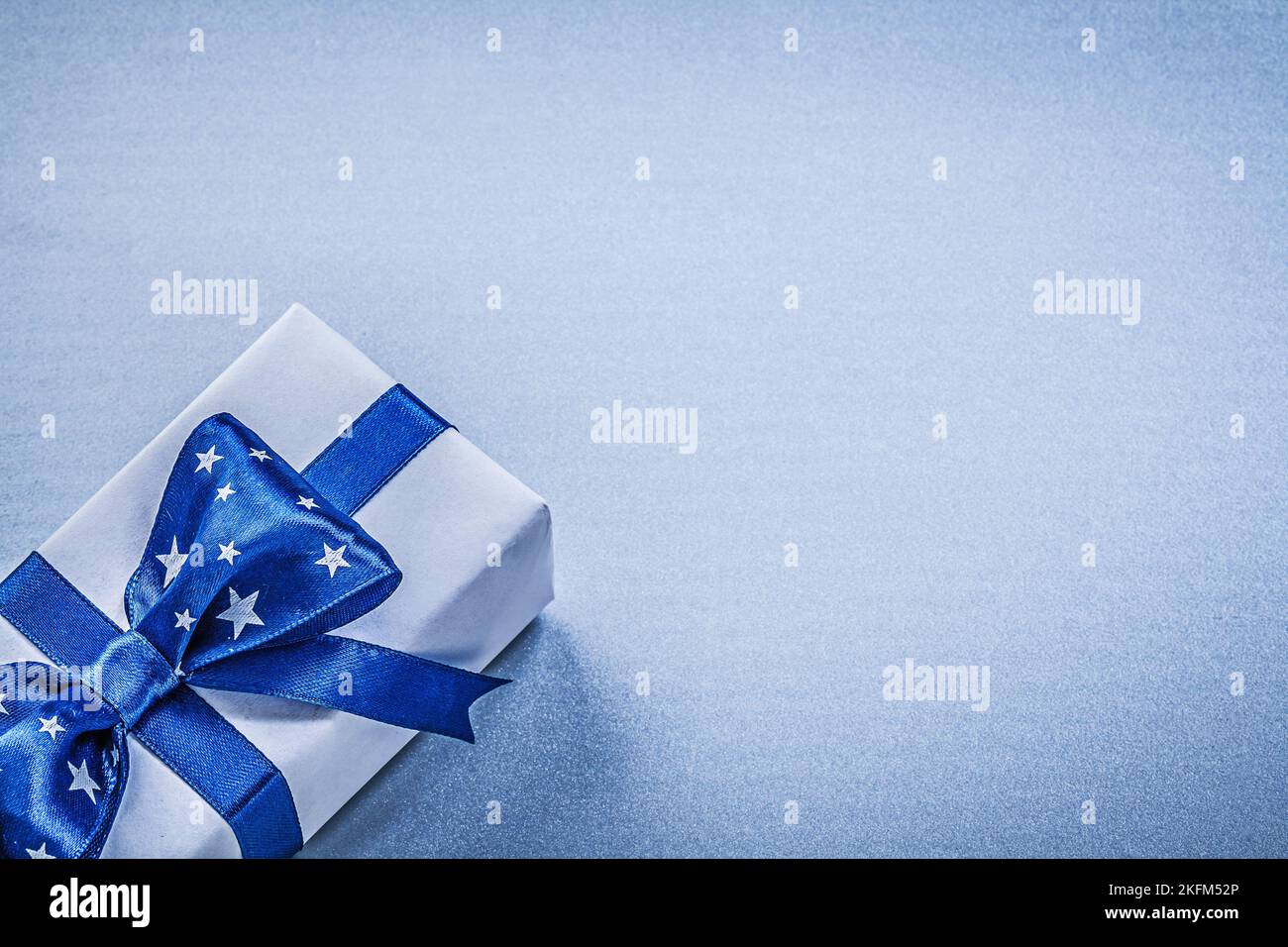 Gift container with tied bow on blue background holidays concept Stock ...