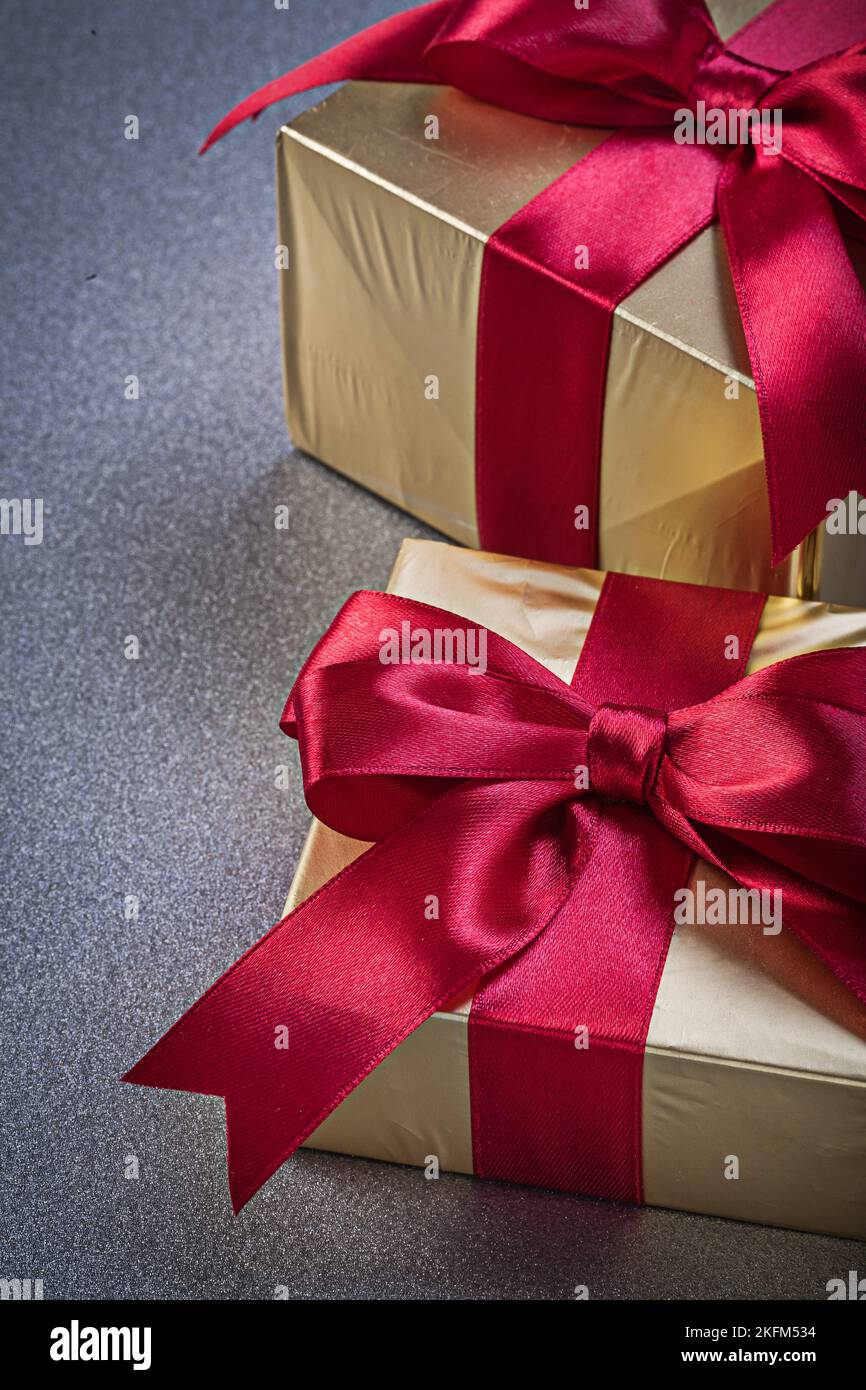 Giftboxes in glittery paper on grey background vertical view holidays ...