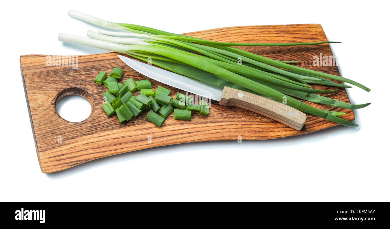 green chopped scallions and kitchen knife on vintage wooden chopping ...