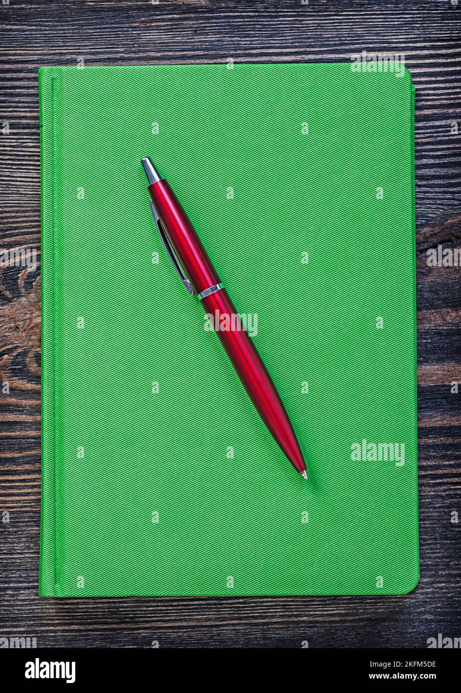 Green notepad ball-point pen on vintage wood board office concept Stock ...