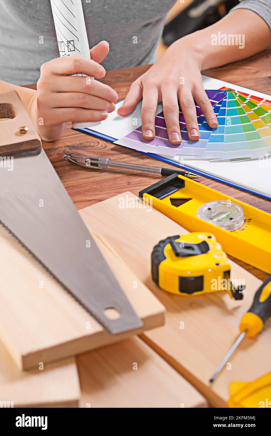 hand of designer on color palette and other tools Stock Photo - Alamy