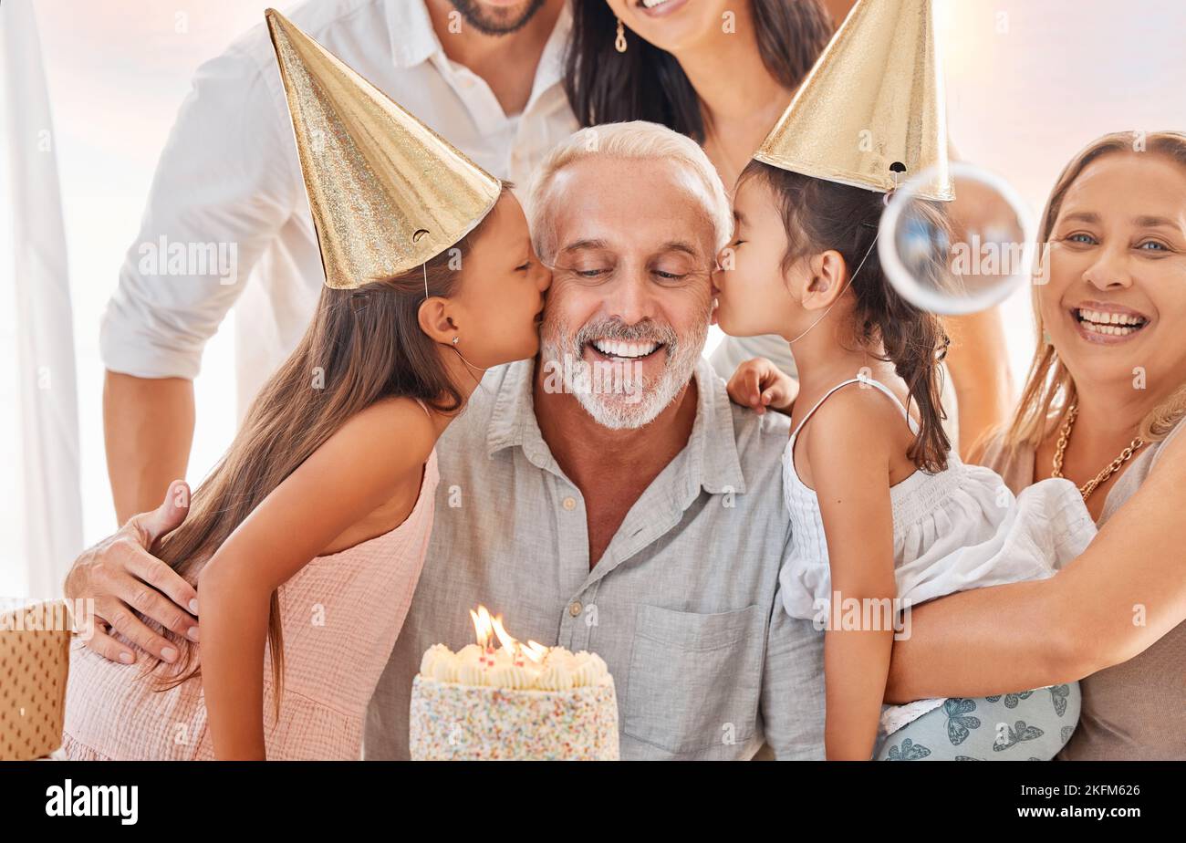 Family, birthday and girls kiss grandfather at home in celebration. Big ...