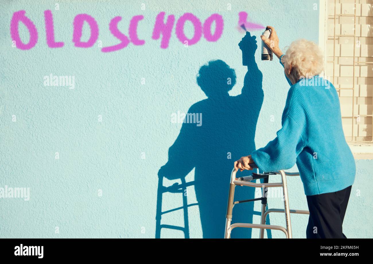 Senior woman, graffiti and wall with spray paint for street art in city ...