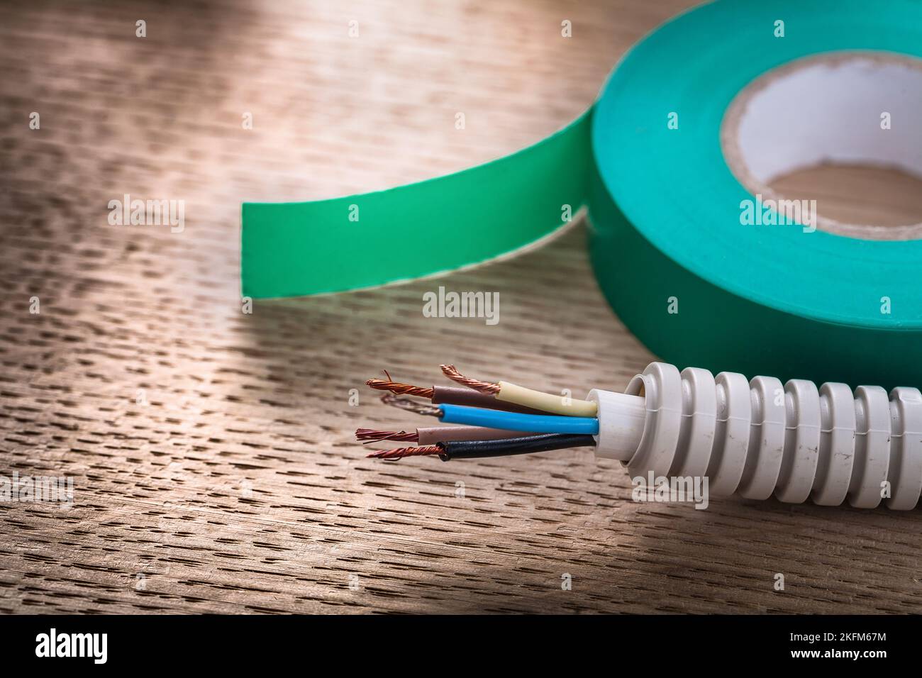 horizontal view roll of green insulating tape and electric cable in ...