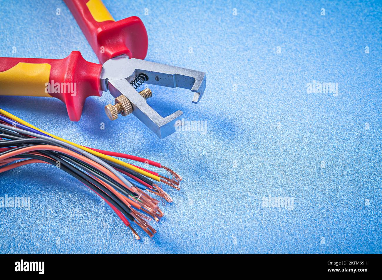Insulated wire strippers electric cables on blue background electricity ...