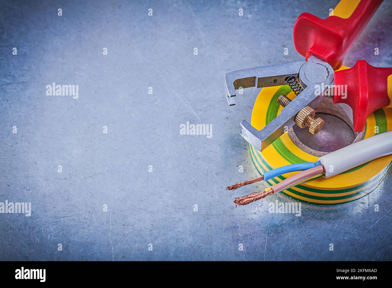 Insulation strippers tape electrical wires on metallic background ...