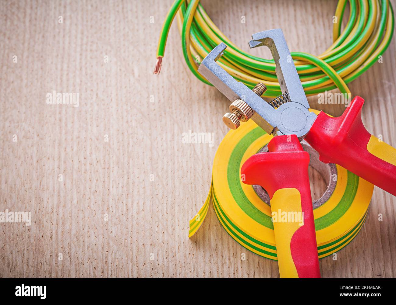 Insulating tape electric cable insulated wire strippers on wooden board ...