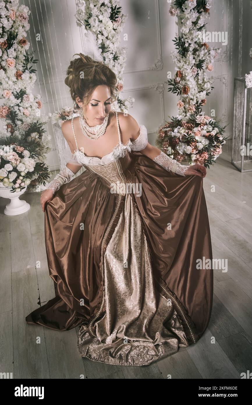 a young woman in an 18th century dress and lace in the boudoir ...