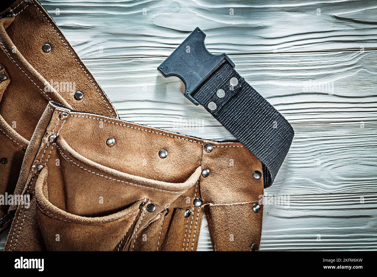 Leather construction belt on white board Stock Photo - Alamy