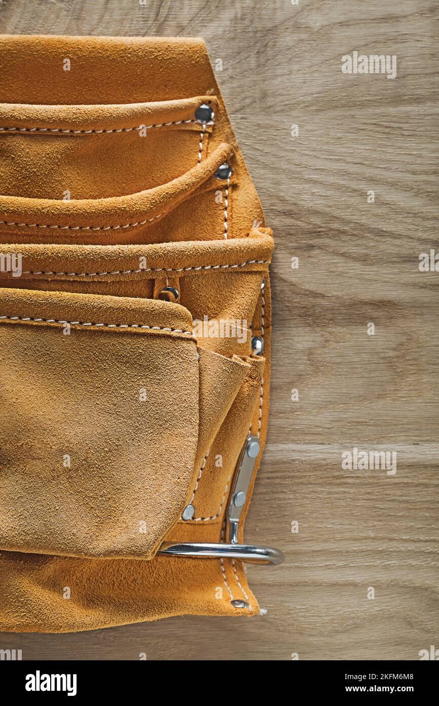 Leather construction belt on wooden board Stock Photo - Alamy
