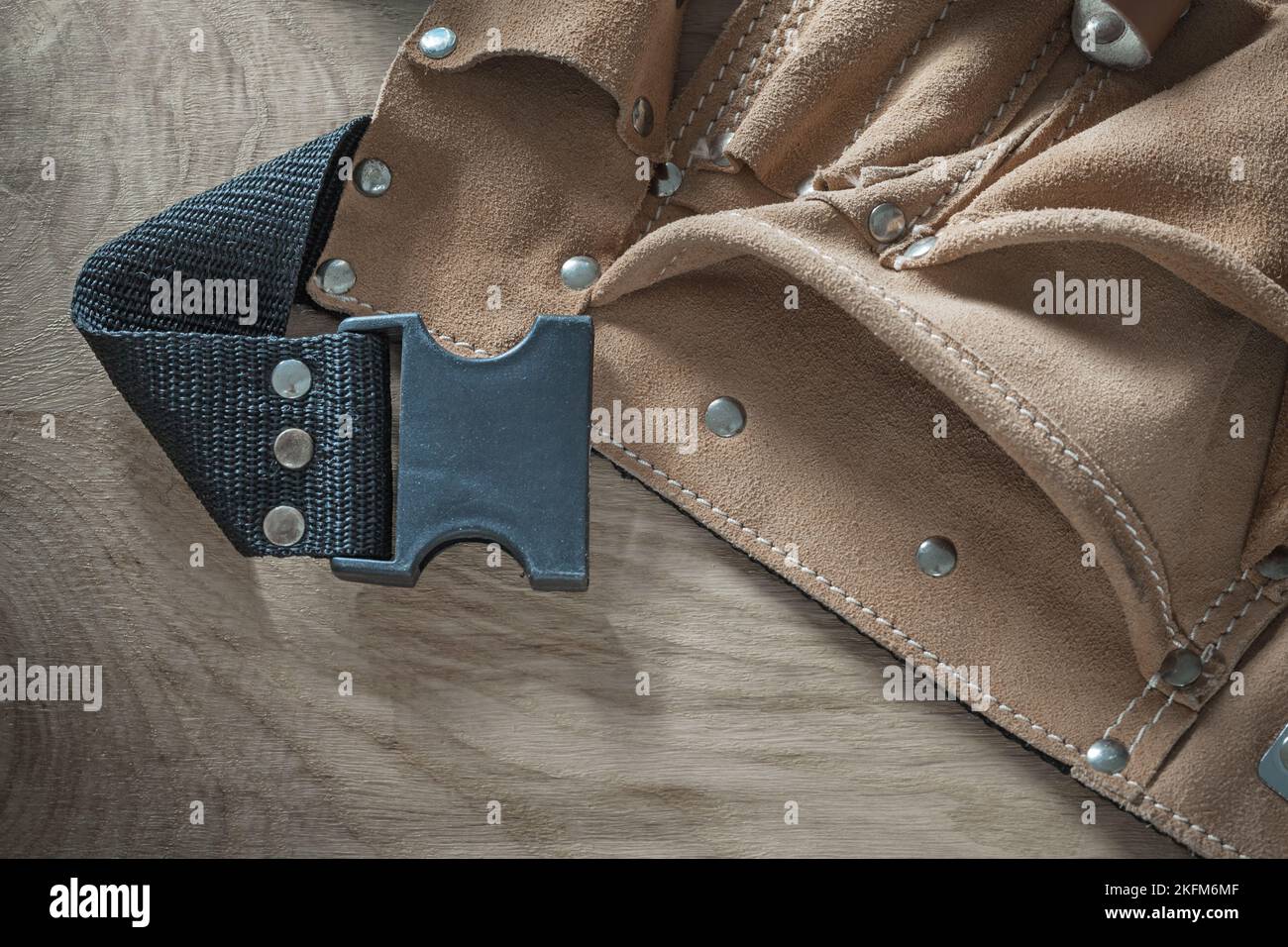 Leather construction belt on wooden board Stock Photo - Alamy