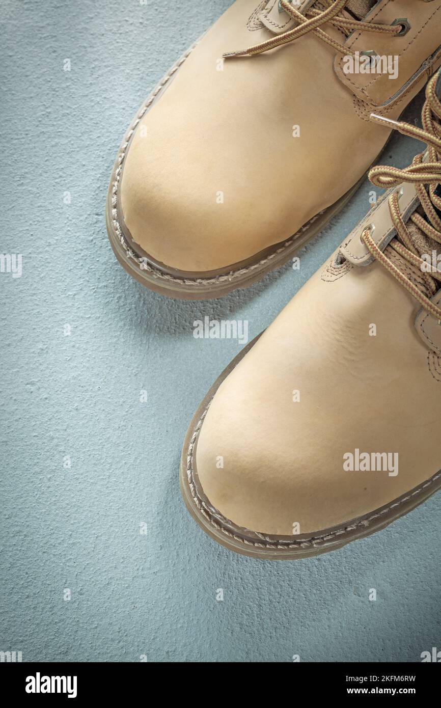 Leather safety boots on concrete background Stock Photo - Alamy