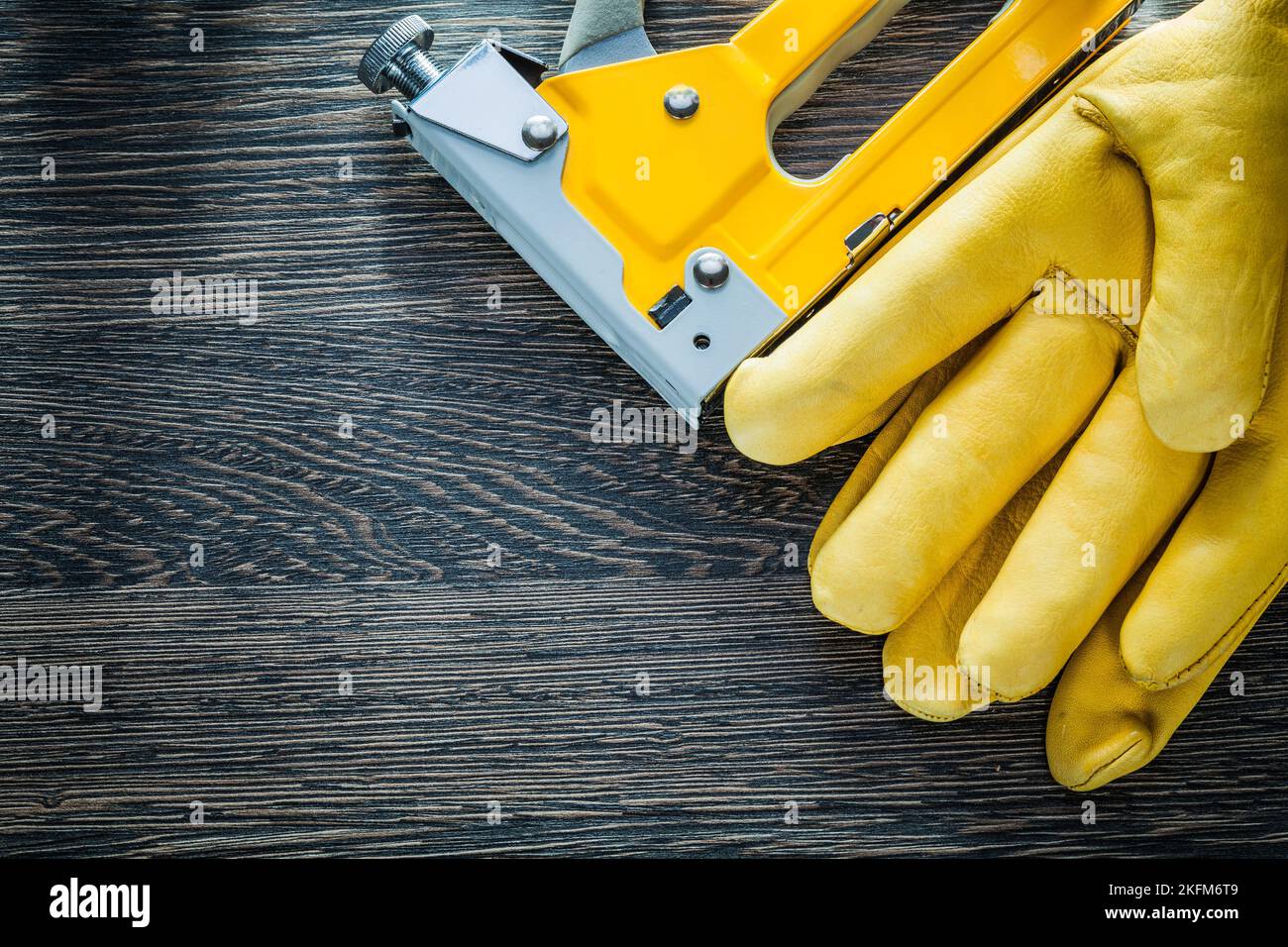 Leather safety gloves construction stapler on wooden board Stock Photo ...