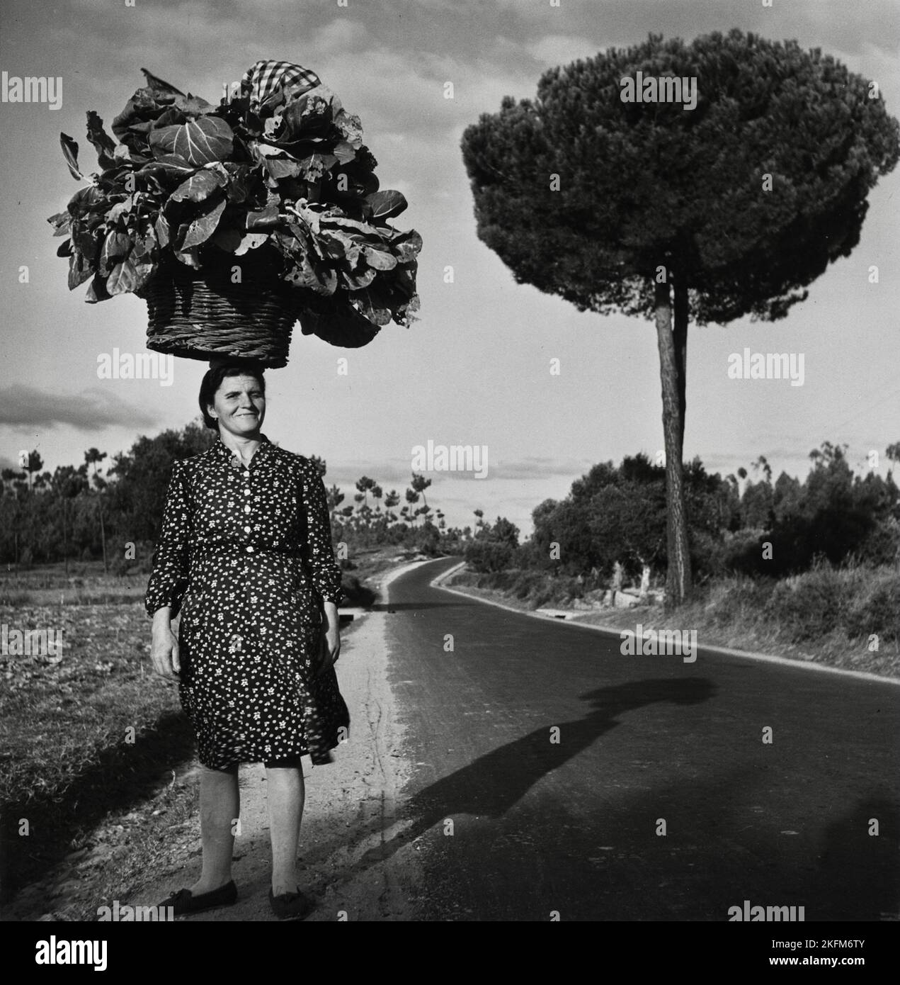 Charles Fenno Jacobs - Portugal. A peasant woman carries her truck ...