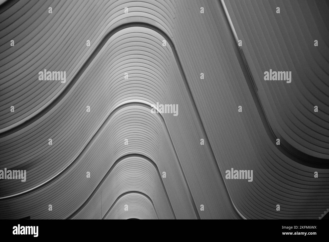 A minimalistic grayscale of modern design of a wall with curvy lines ...