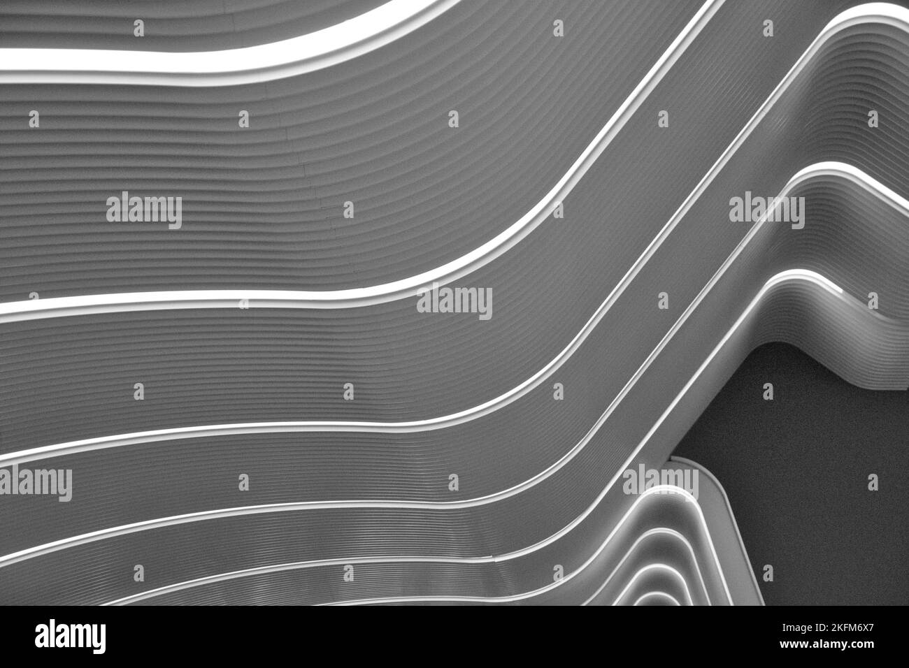 A grayscale of modern design of a wall with curvy light lines Stock ...