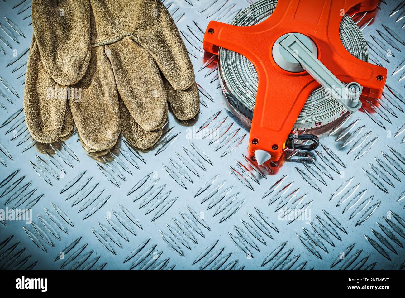 Leather safety gloves measuring tape on fluted metal sheet Stock Photo ...