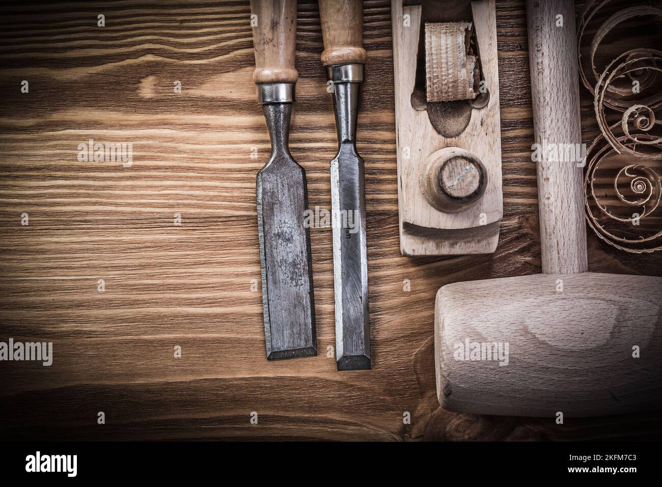 Lump hammer planer firmer chisels planning chips on vintage wood board ...