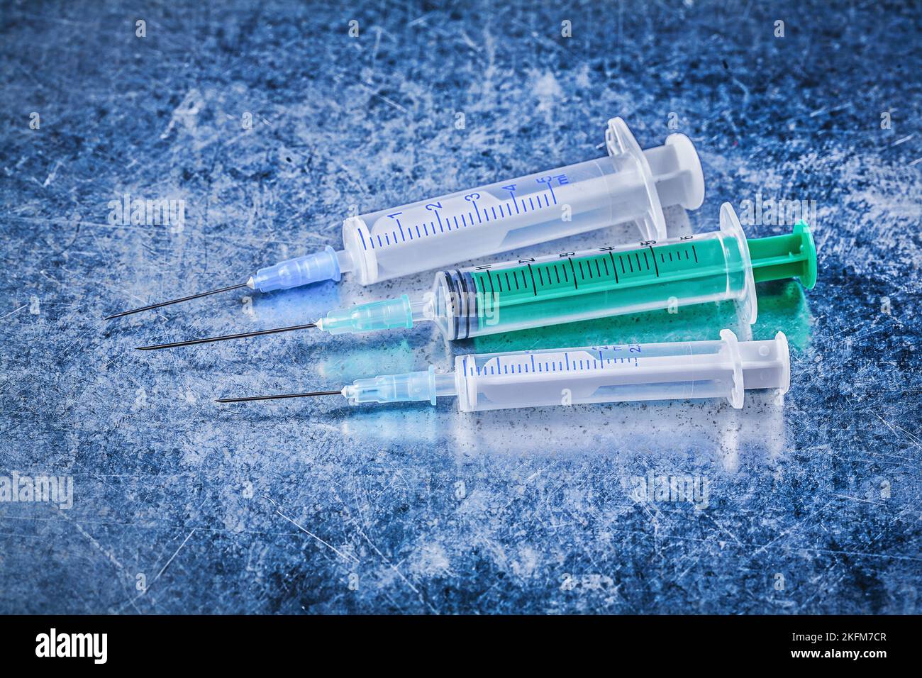 Medical disposable needle injectors on metallic background medicine ...