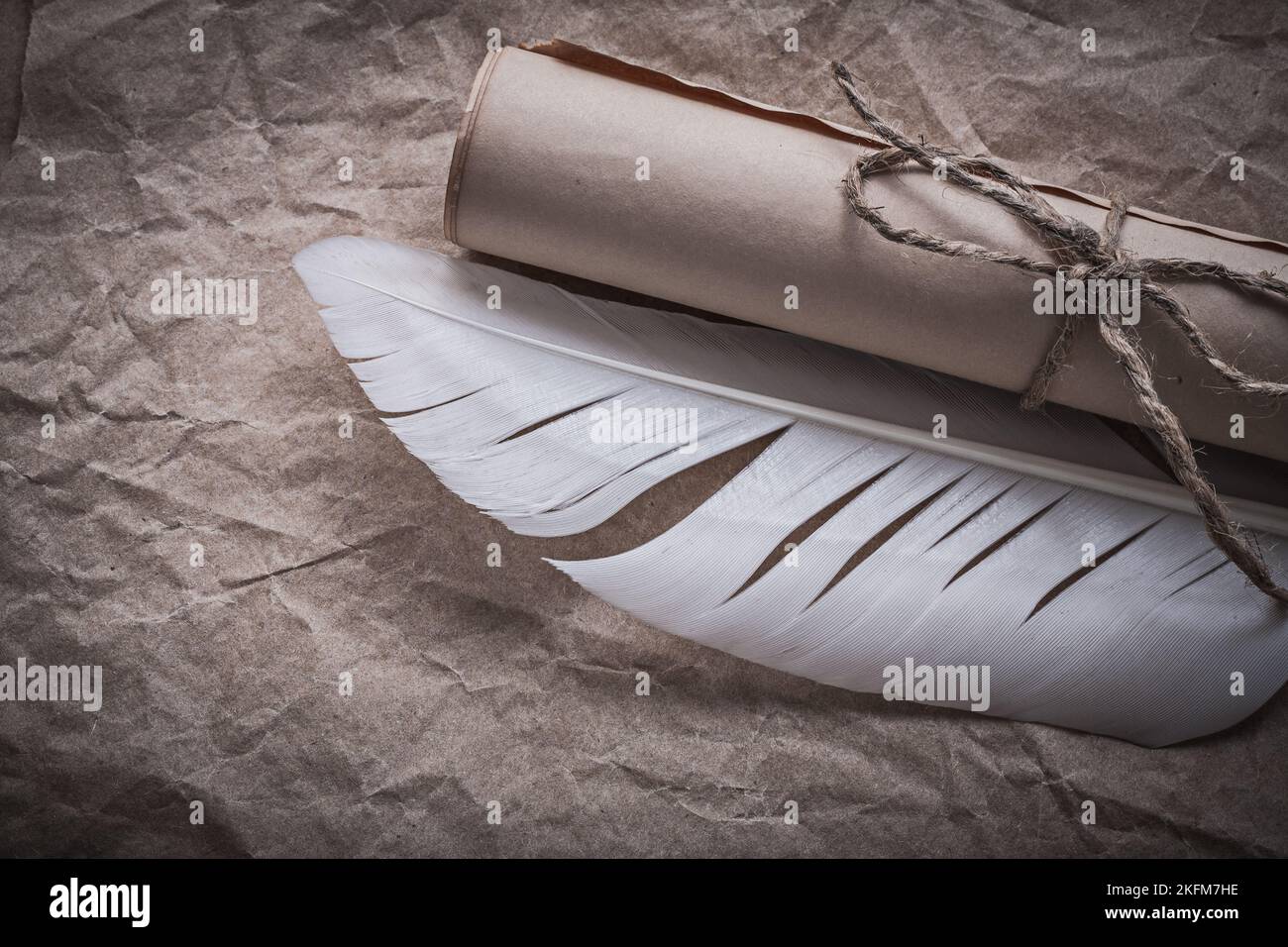 Medieval corded paper roll feather on crumpled wrapping sheet Stock ...