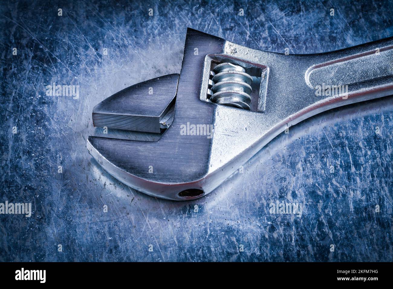 Metal adjustable spanner on scratched metallic background construction ...