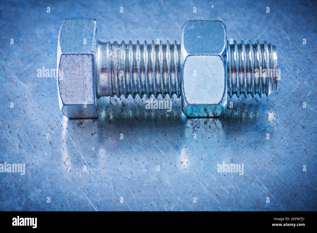 Metal bolt with screw-nut on metallic background construction concept ...
