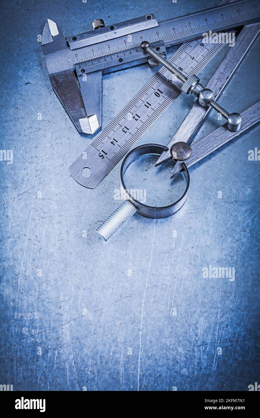 Metal ruler slide caliper construction compasses on scratched metallic ...