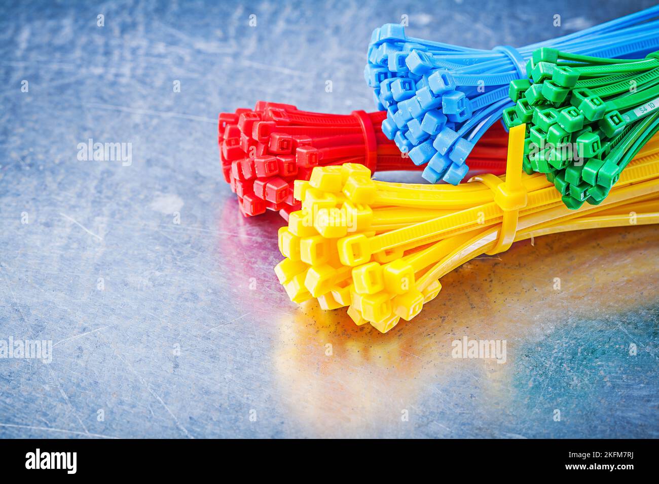 Multicolored plastic tying cables on metallic background construction ...
