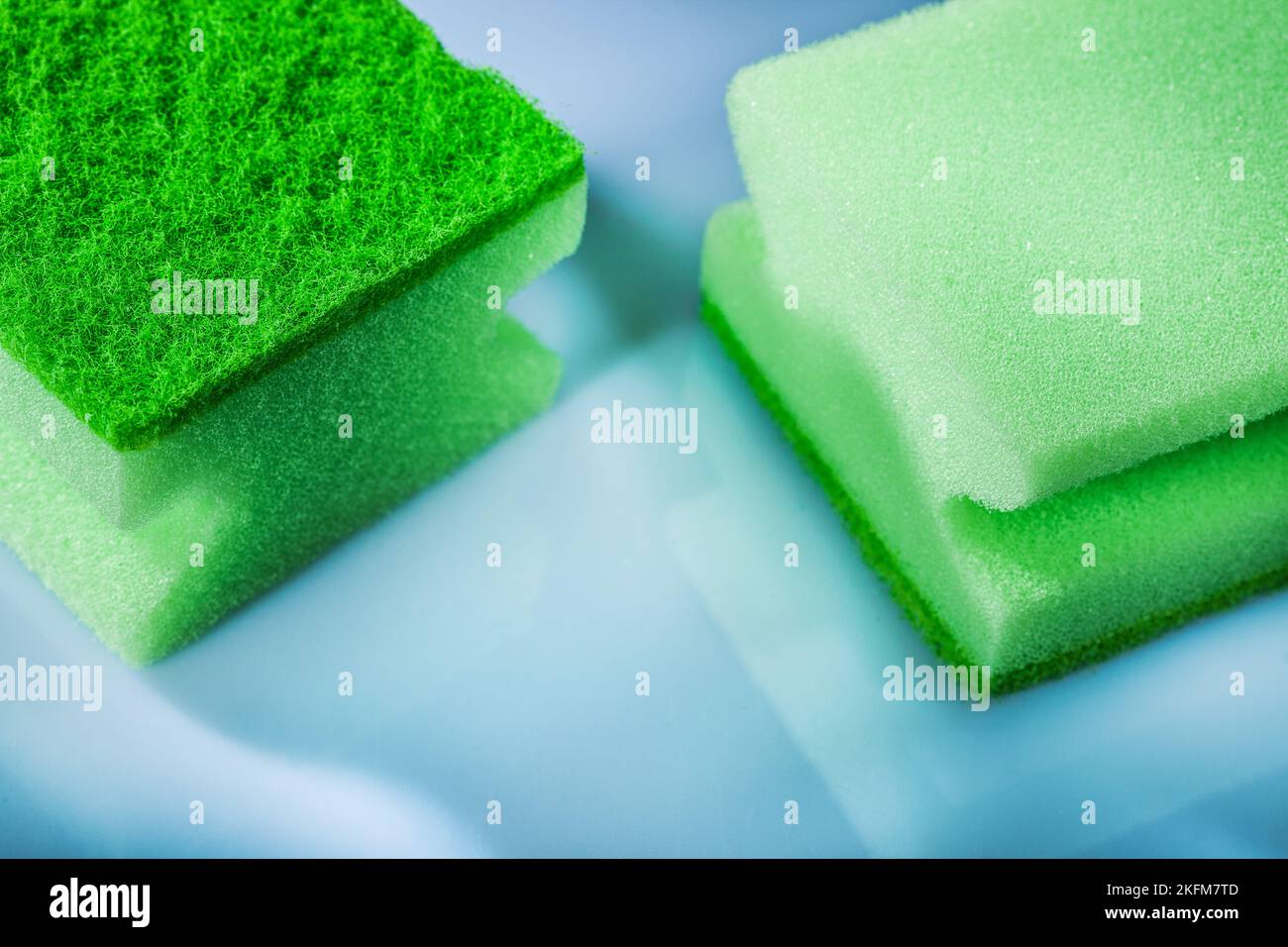 New green kitchen sponges on white background Stock Photo - Alamy