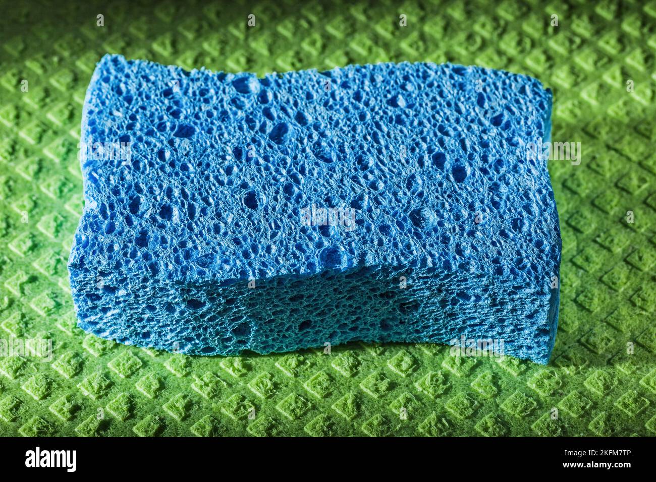 New blue sponge on dishcloth Stock Photo - Alamy
