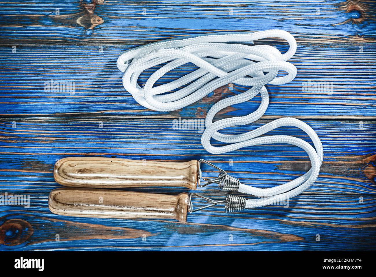 New jumping rope on vintage wooden board Stock Photo - Alamy
