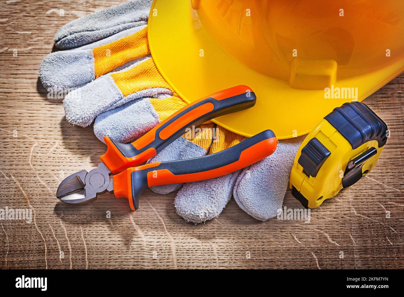Nippers safety gloves hard hat tape measure on wooden board Stock Photo ...