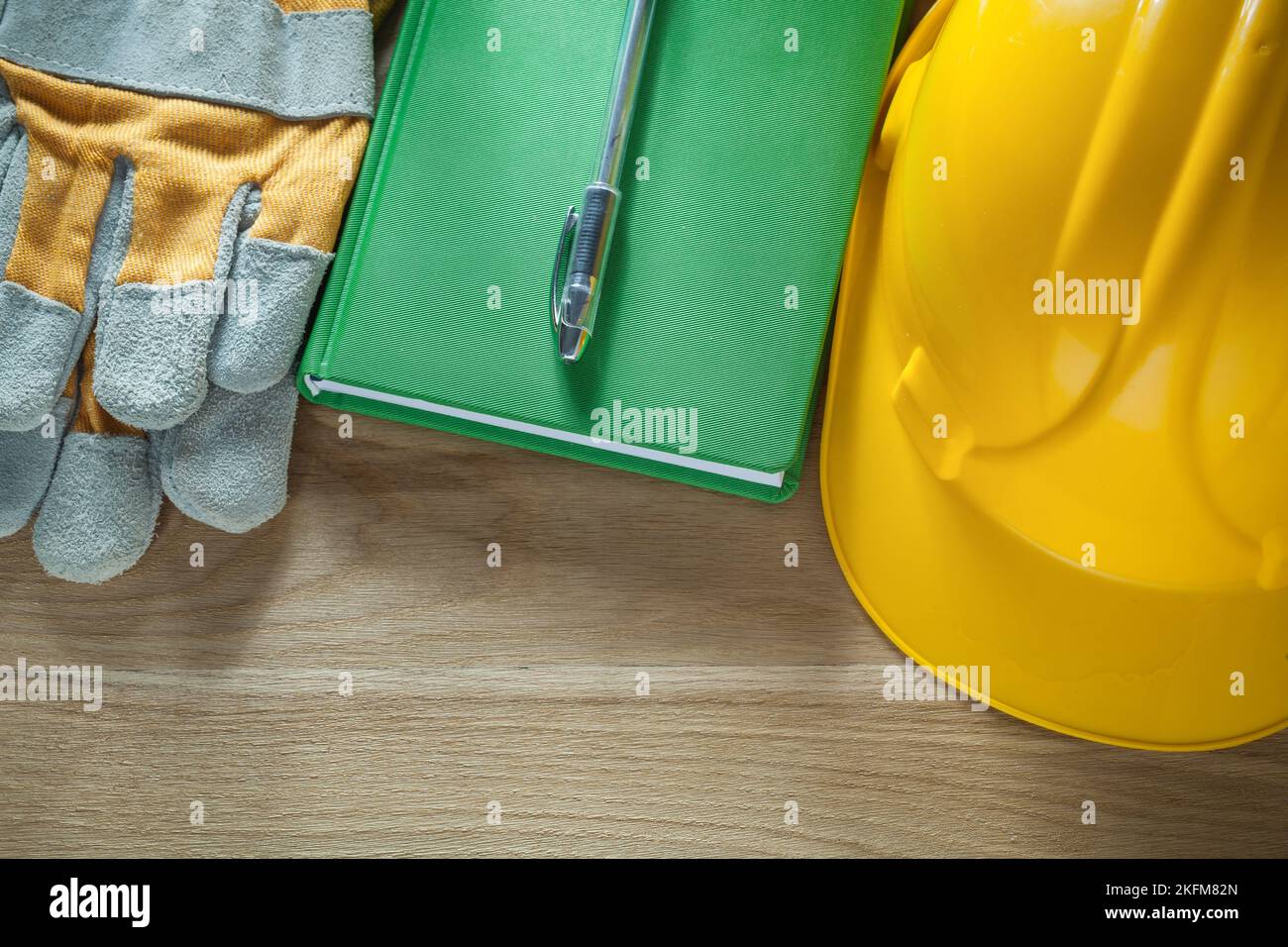 Notepad ballpoint pen safety gloves building helmet Stock Photo - Alamy