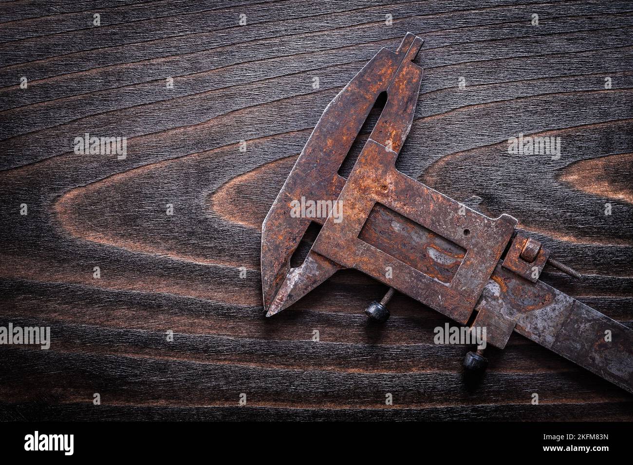 Obsolete metal vernier caliper on vintage wooden board construction ...