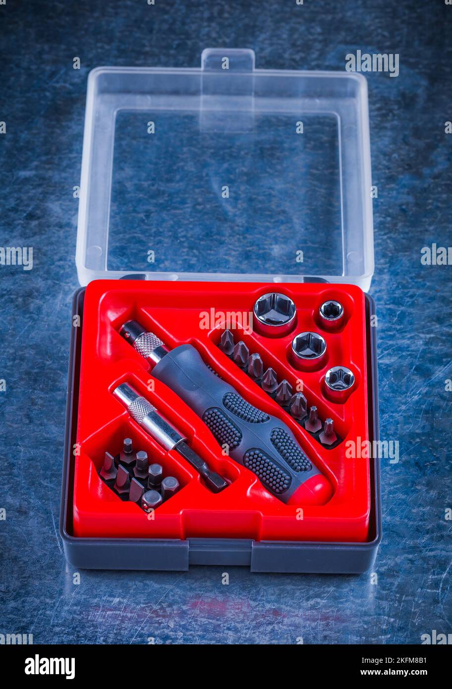 Opened toolbox with screwdriver and replaceable bits on scratched ...