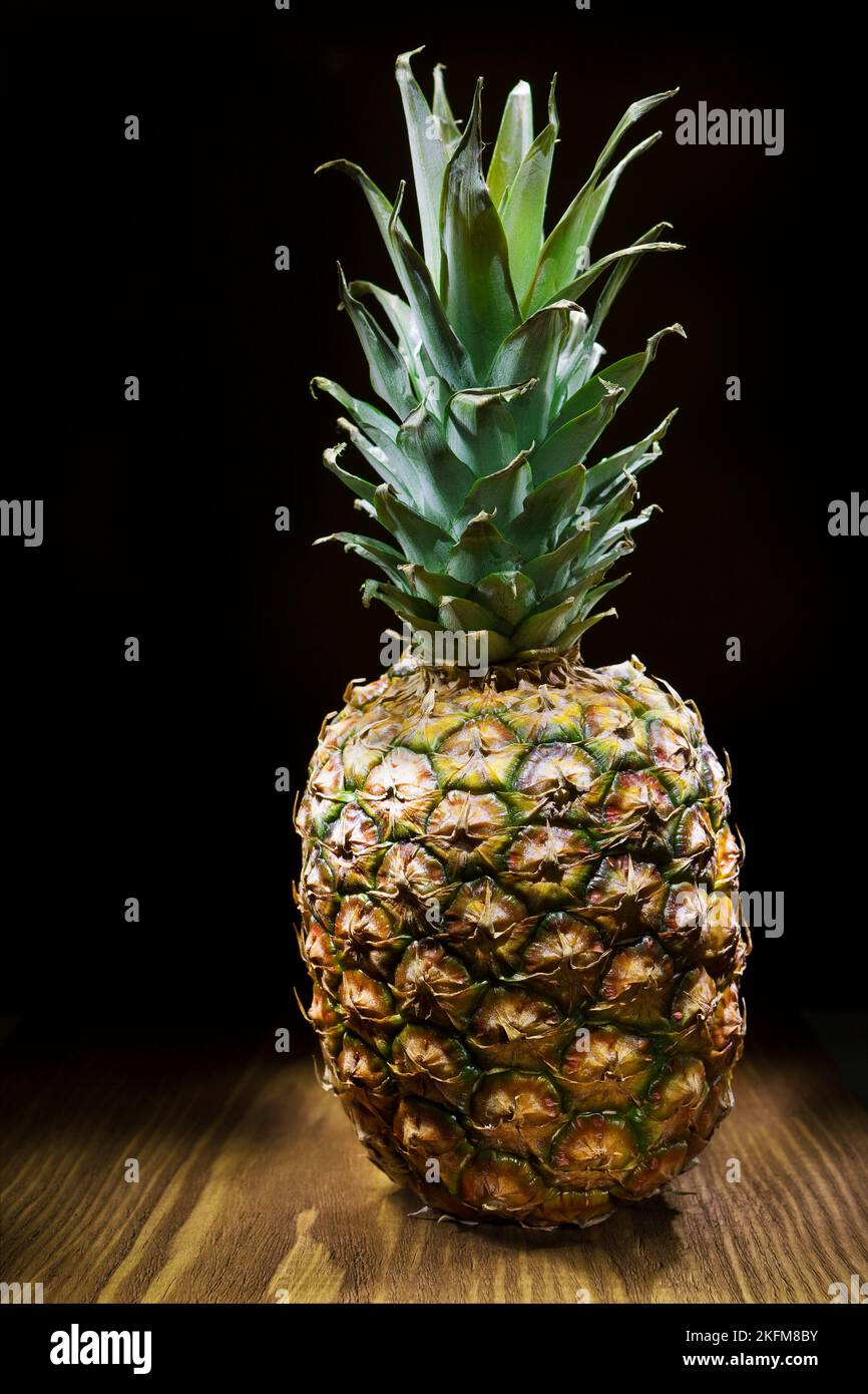 one pineapple on wooden board Stock Photo - Alamy